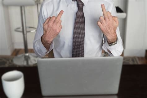 Premium Photo Close Up Of Man Working Showing Middle Finger To Laptop Screen