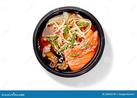 Japanese Udon Noodle Soup With Salmon Shrimps And Squid Served With Scallions And Sesame Stock