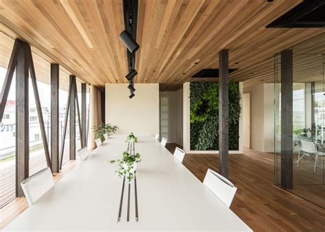 Tree Grows Through Voids In Hamada Designs Glass Wood Building