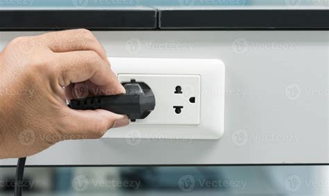 Hand Unplugging A Plug From A Socket 21790792 Stock Photo At Vecteezy
