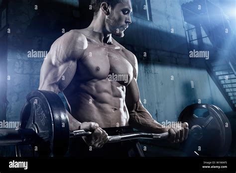 Muscular Man Doing Barbell Biceps Curls Exercise Stock Photo Alamy