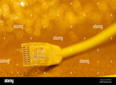 A High Resolution Closeup Of A Yellow Ethernet Cable Lying On A Bright Yellow Background Stock