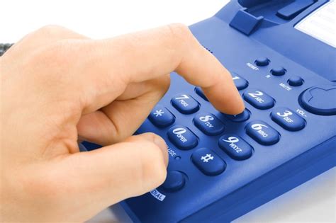 Premium Photo Fingers Dialing Number On Telephone