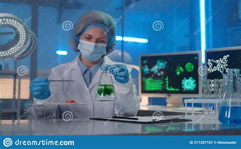 A Female Scientist Observes The Dissolution And Spread Of A Green