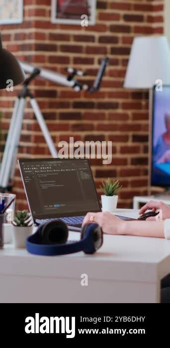 vertical video software developer types programming code in a cozy home