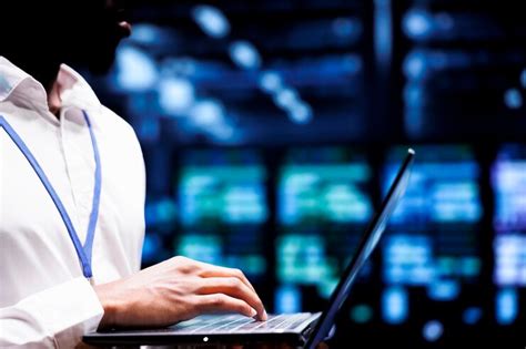 Premium Photo Employee Using Laptop To Do Checkup On Supercomputers With High Computing Power