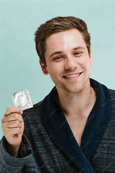 Premium Photo Portrait Of A Blond Man Showing A Latex Condom