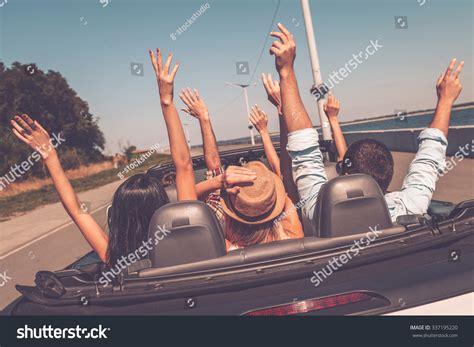 Enjoying Road Trip Rear View Of Young Happy People Enjoying Road Trip