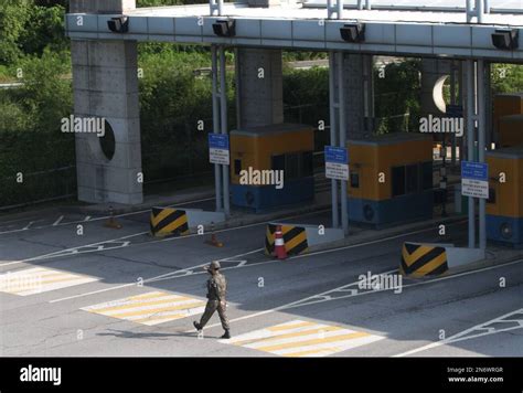 A South Korean Army Soldier Patrols Before South Korean Business Men