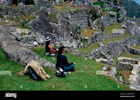Women Meditating At The Sacred Site Of Inticancha Machu Picchu Peru