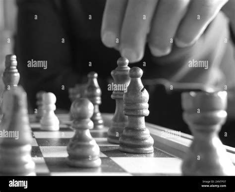 A Closeup Shot Of Hand Of A Male Chess Player Moving The Chess Piece