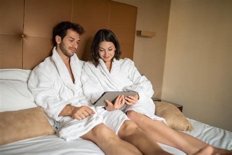 Premium Photo Couple In Bed Sharing A Digital Tablet