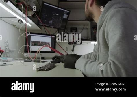 Electronic Renovation In Repair Shop Testing Electric Current In The Motherboard Using