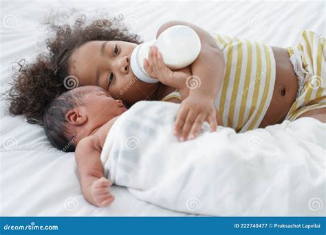 Little African Older Sister Sucking Milk From Bottle Hugging And Take