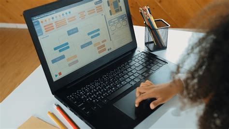 Premium Photo Smart African Girl Moving Touch Pad While Use Laptop Programing Code Erudition