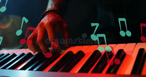 Image Of Notes Moving Over Caucasian Man Playing Keyboard Stock Image