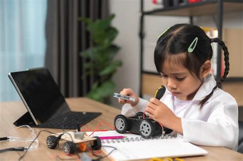 Premium Photo Asian Littlle Girl Constructing And Coding Robot At