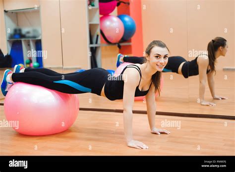 Happy Cutie Athletic Girl Execute Exercise And Smile In Sport Hall