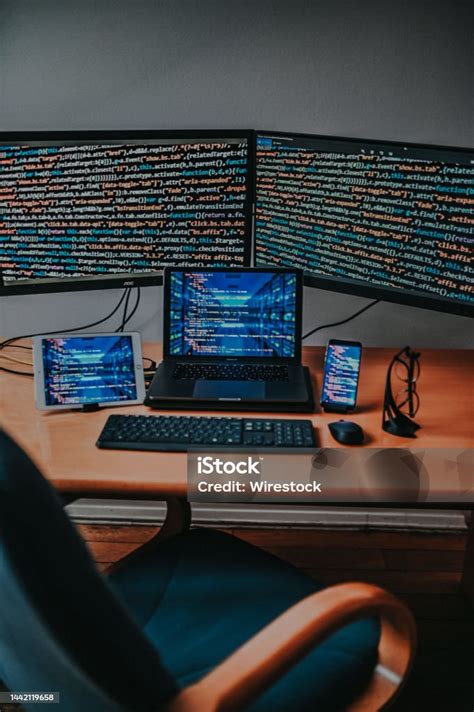 Vertical Shot Of Programmers Desk With Types Of Electronic Equipment