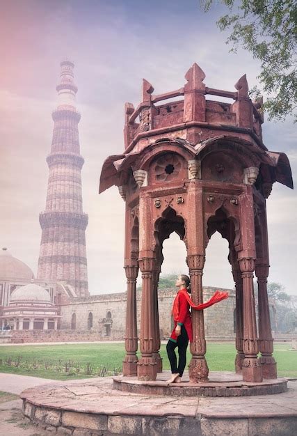 Premium Photo Woman In Red Near Qutub Minar Complex