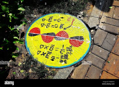 A Manhole Cover Is Decorated With Special Cartoon Graffiti
