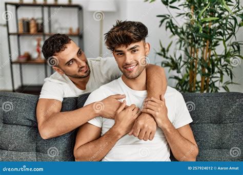 Two Hispanic Men Couple Smiling Confident And Hugging Each Other At