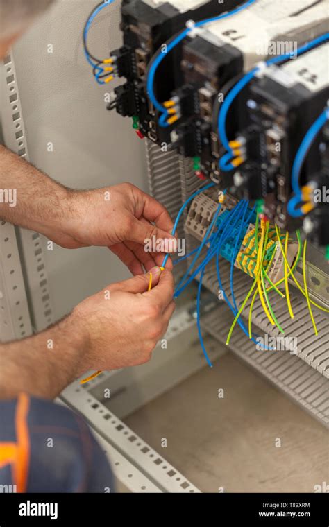 Electrician Connecting Wire On The Control Panel Close Up Stock Photo Alamy