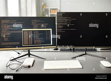 Background Image Of Two Computers On Desk With Code Lines On Screen In It Developers Office