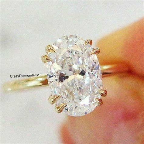 Simple Double Claw Oval Engagement Ring In Yellow Gold Elegant Oval