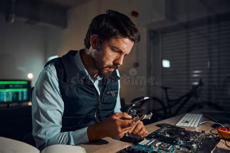 Man Circuit And It Repair Workshop In Night For Maintenance Computer Tech Or Industry With