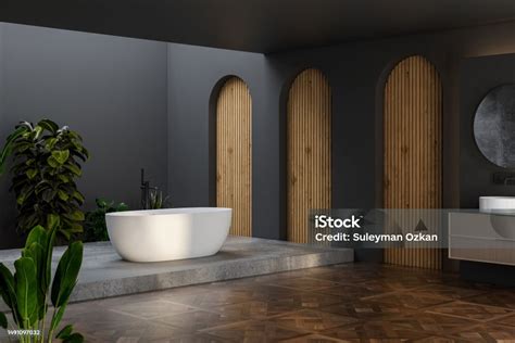 쪽모이 세공 마룻바닥 아치 어둡고 나무로 된 벽 욕조 타원형 거울과 나무 세면대가 있는 더블 화이트 세면대가 있는 세련된 회색 욕실 인테리어 3d 렌더링 복사 공간 모형 0