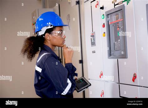 Electrical Young Asian Woman Engineer Examining Maintenance Cabinet System Electric And Using