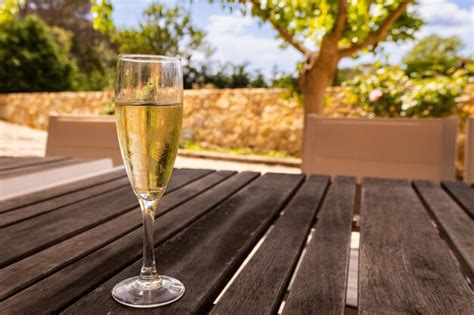 Premium Photo A Glass Of Cava On A Brown Table With A Blurred Background