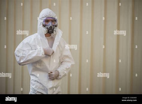 Man In Personal Protective Equipment Ppe Suit Wearing Clear Glasses And Protective Gas Mask