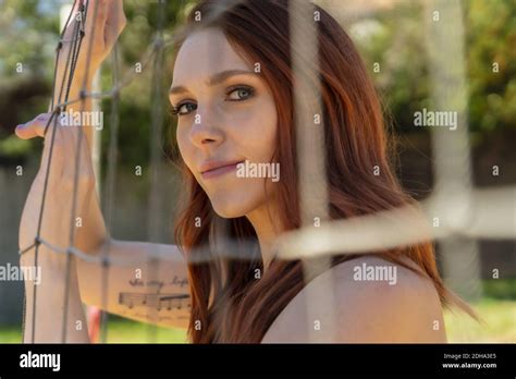 A Gorgeous Redhead Fitness Model Preparing To Play Volleyball Stock Photo Alamy
