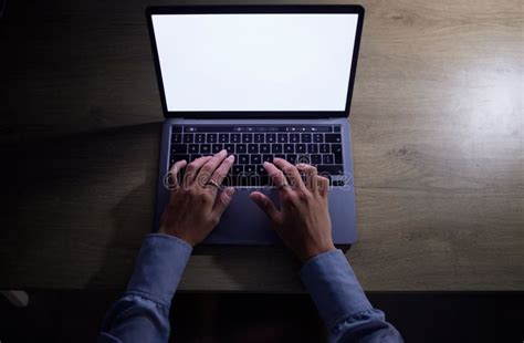 Person Coding At A Desk Surrounded By Multiple Monitors In A Modern Office During Evening Hours