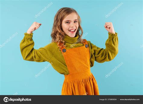 Photo Amusing Blonde Girl Showing Her Biceps Smiling Isolated Blue