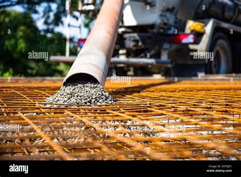 Concrete Being Poured Onto Rebar Framework For Ground Slab Construction
