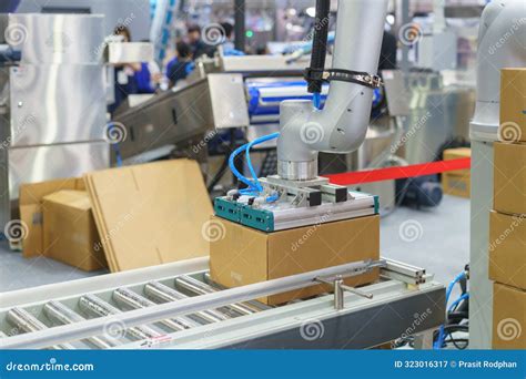 Automated Robotic Arm In Industrial Packaging Royalty Free Stock
