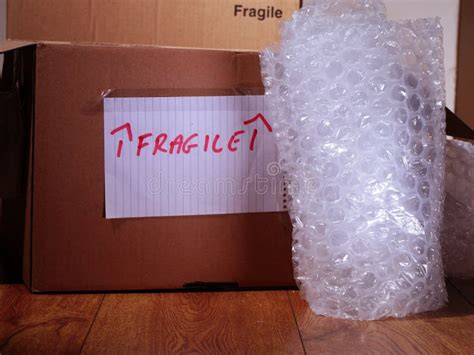 Moving Fragile Items With Cardboard Boxes And Bubble Wrap Stock Image