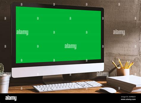 Chroma Key Green Screen Computer With White Cover Magazine Stack On Table Table Top Shot Of