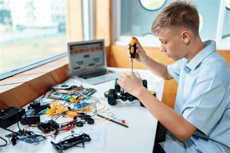 Student Fixing Robotics Vehicle Learn Technology In Stem Class