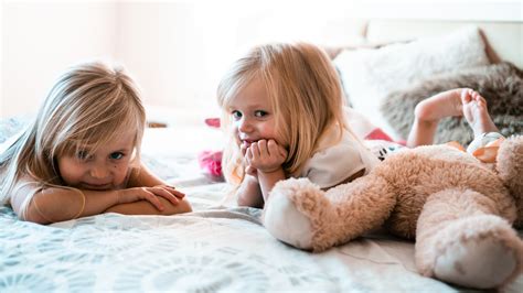 흰색 머리 장식을 입고 흰색 봉제 장난감을 들고있는 2 명의 아기 · 무료 스톡 사진