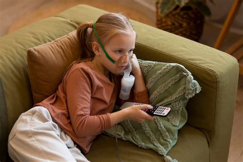 Free Photo High Angle Girl Using Nebulizer