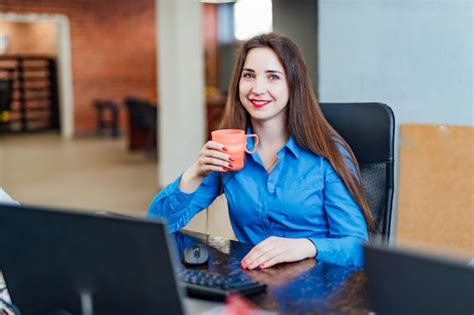 Premium Photo Young Woman Programmer Sitting In A Companyfice In Front Computer With A Pink