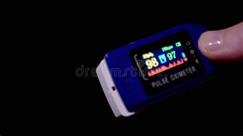 Woman Measures Pulse And Oxygen Saturation Using A Pulse Oximeter At Home Stock Video Video Of