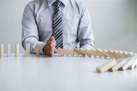 Premium Photo Midsection Of Businessman Blocking Wooden Block On Table