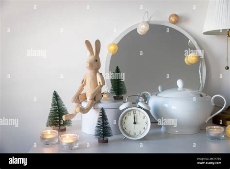 A White Alarm Clock A Twelve Pointer A Hinged Wooden Hare A Small Artificial Green Christmas