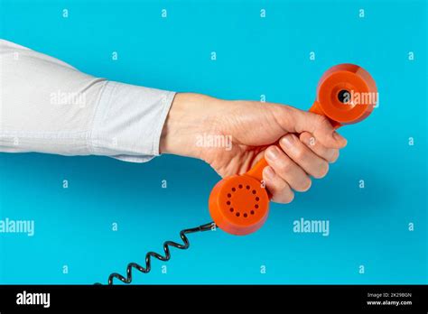 Old Telephone Receiver In Hand Over Blue Background Stock Photo Alamy