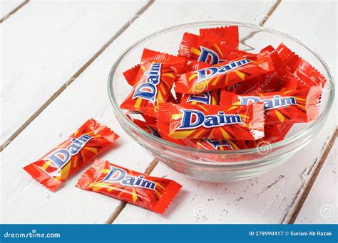 Daim Milk Chocolate And Caramel Candy On A Wooden Table Editorial